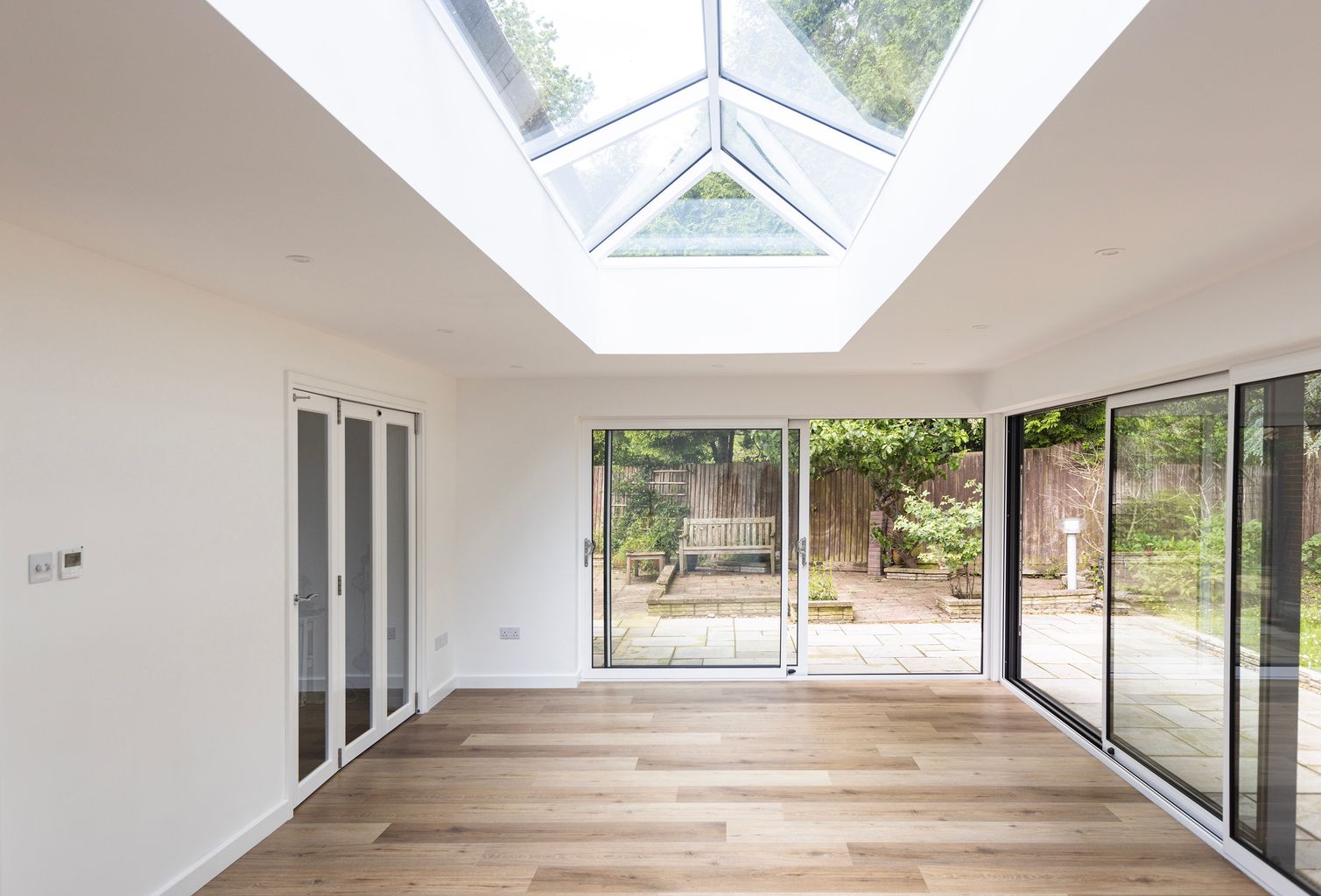 View of living space, roof lantern & sliding doors | homify